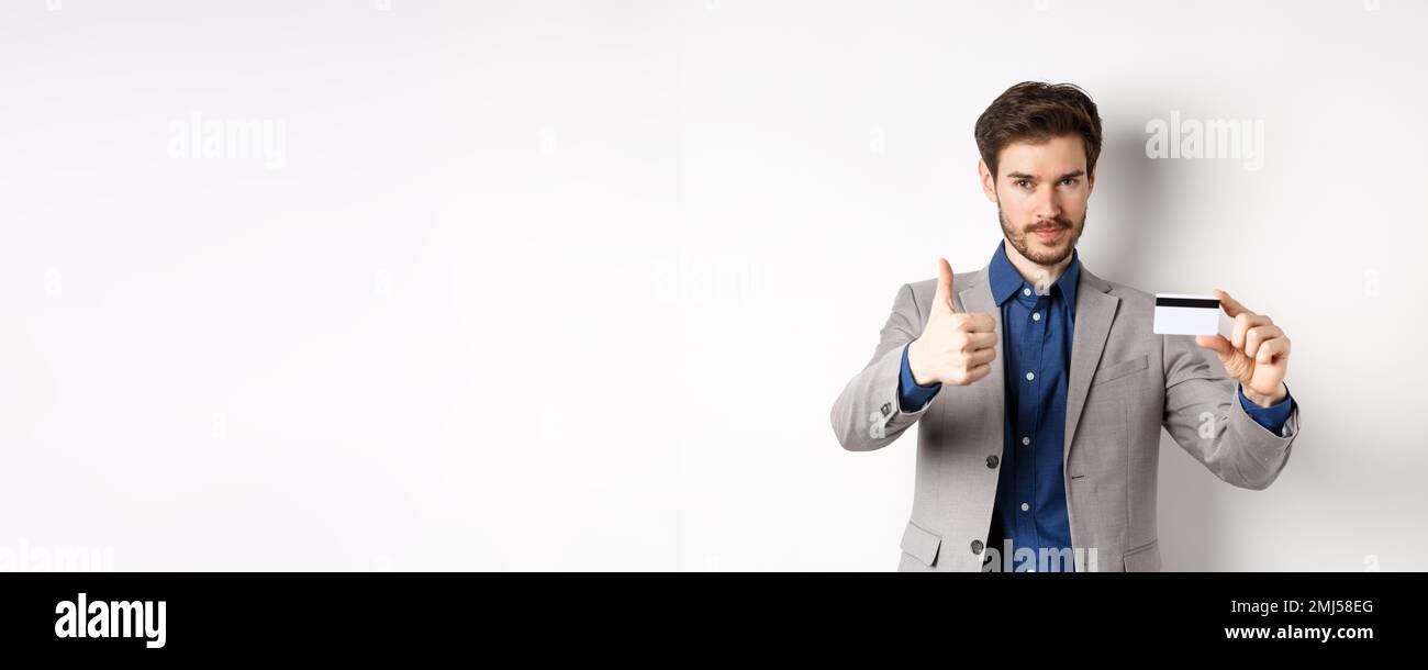 Very good bank. Businessman in suit show plastic credit card and thumb ...