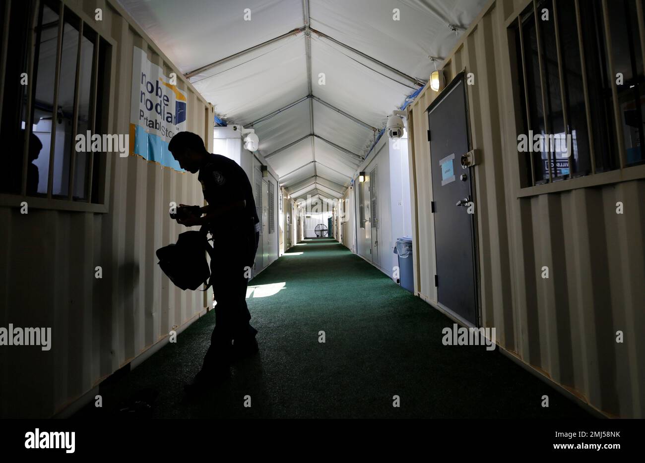 Pods are lined up and used as interview rooms at a new tent courtroom ...