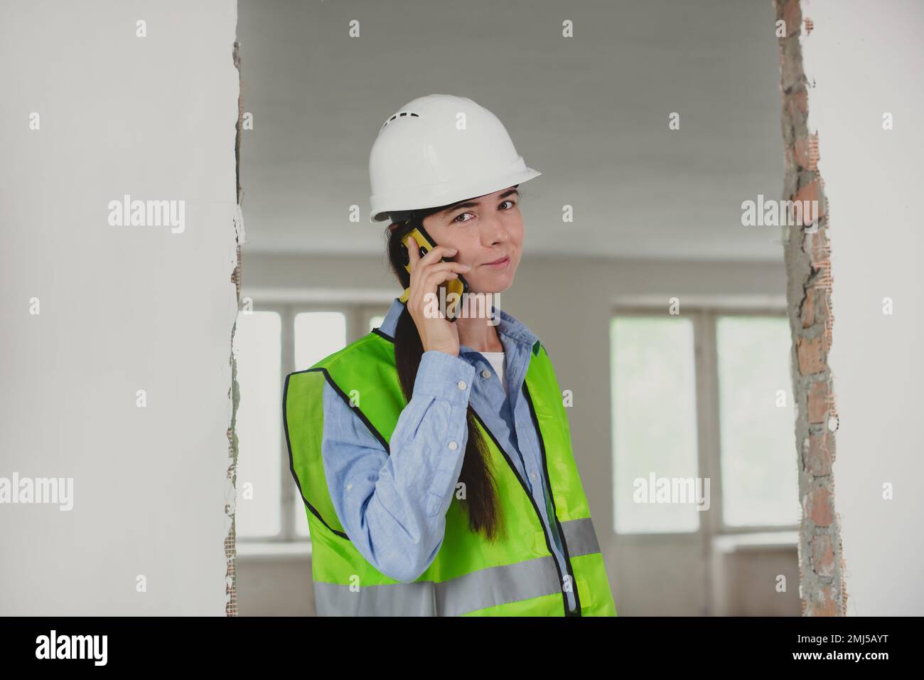 foreman woman consults clients on mobile phone. Inspector or Safety ...