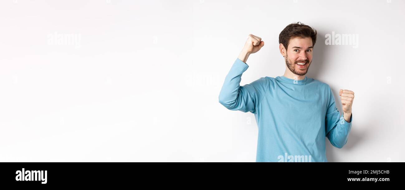 Happy bearded man celebrating victory, raising hands up and triumphing ...