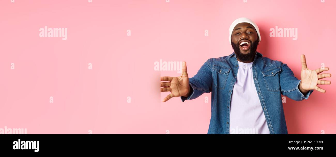 Happy Black man stretching hands, reaching for hug or take something ...