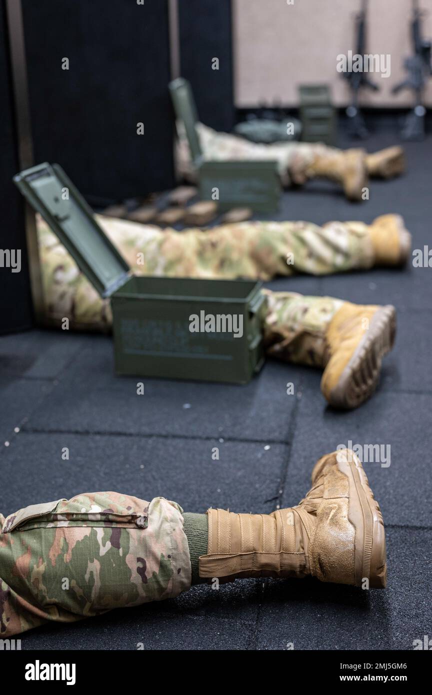 U.S. Airmen lay in the prone position while firing M4 carbine rifles ...