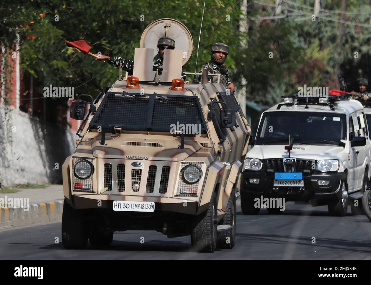 Indian paramilitary soldiers move in armored vehicles outside the ...