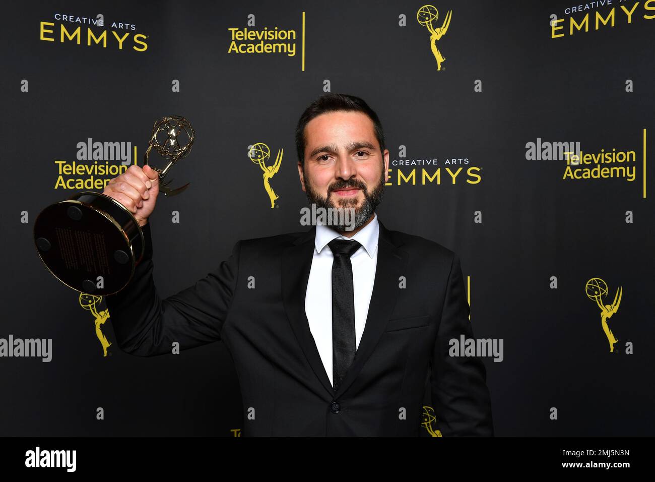 Vincent Piponnier poses for a portrait with the award for outstanding ...