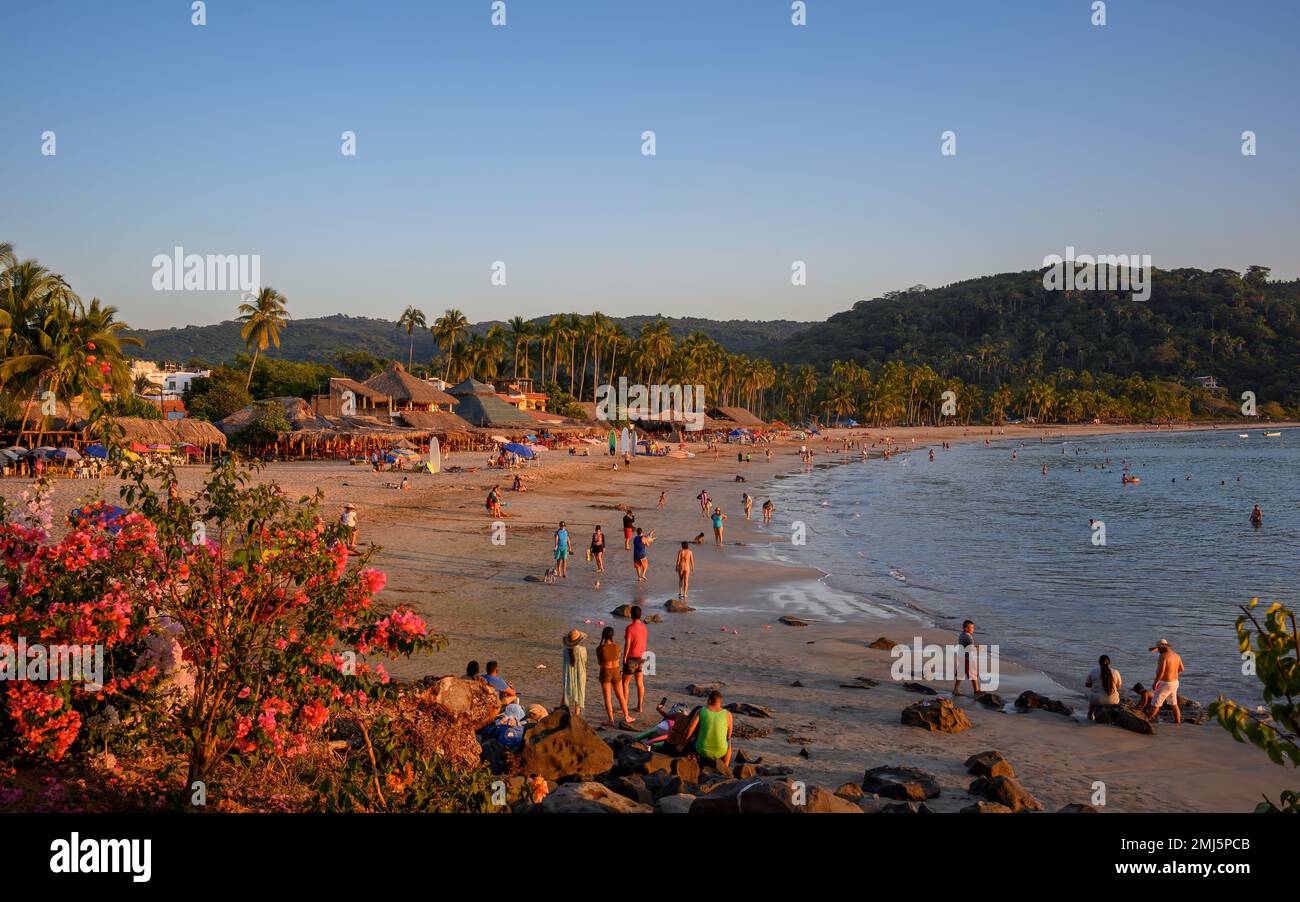 Visitors on the beach at Chacala on Mexico's Riviera Nayarit coast ...