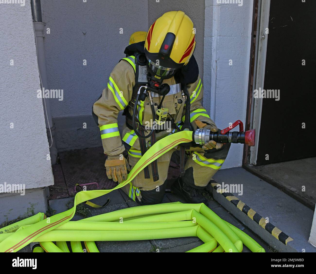 A U.S. Army Garrison Fire Department member prepares his handline ...