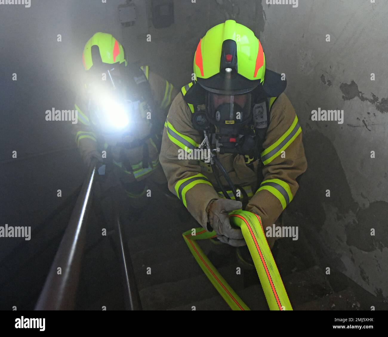 U.S. Army Garrison Fire Department members moves into position during a ...