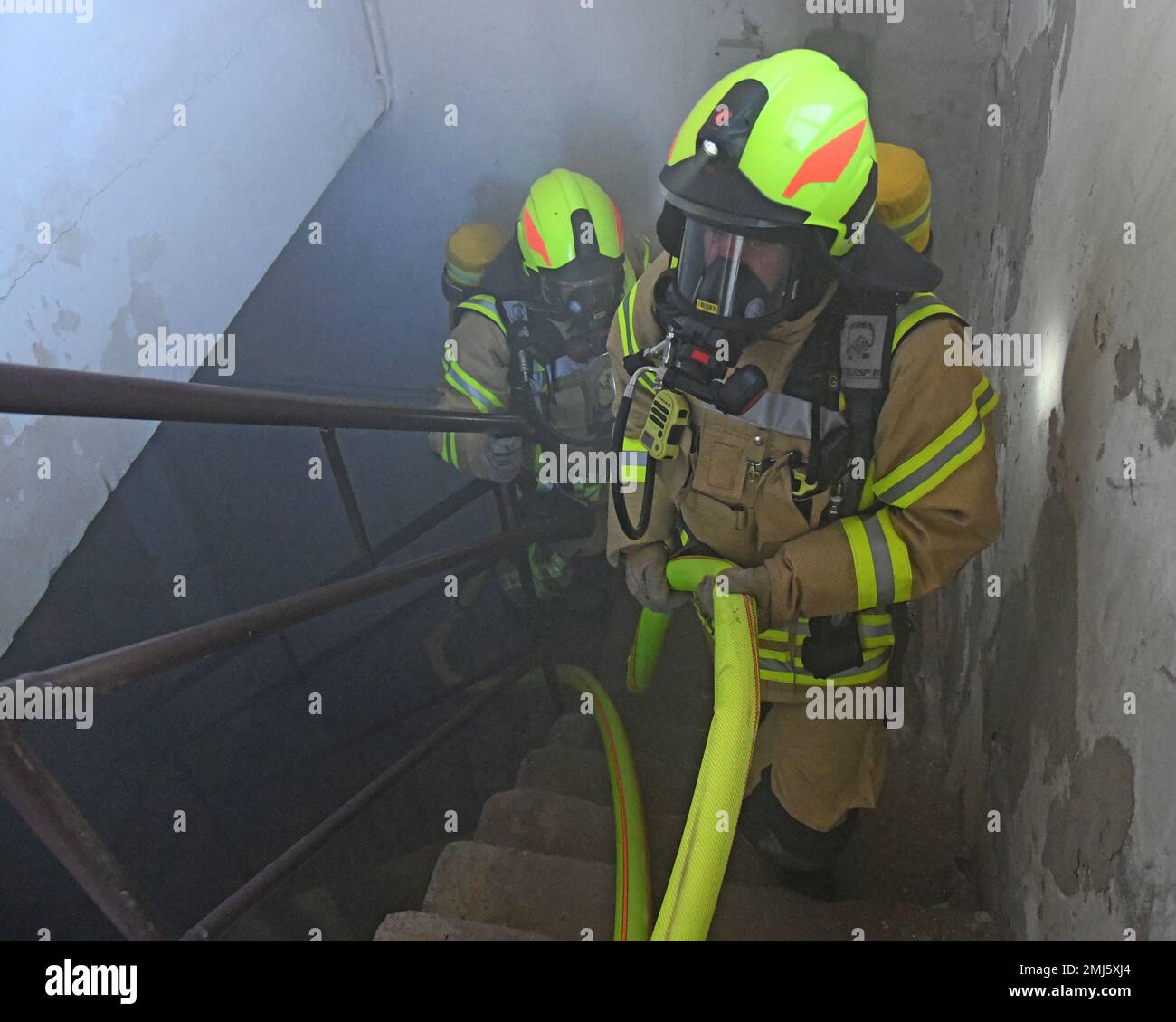 U.S. Army Garrison Fire Department members moves into position during a ...