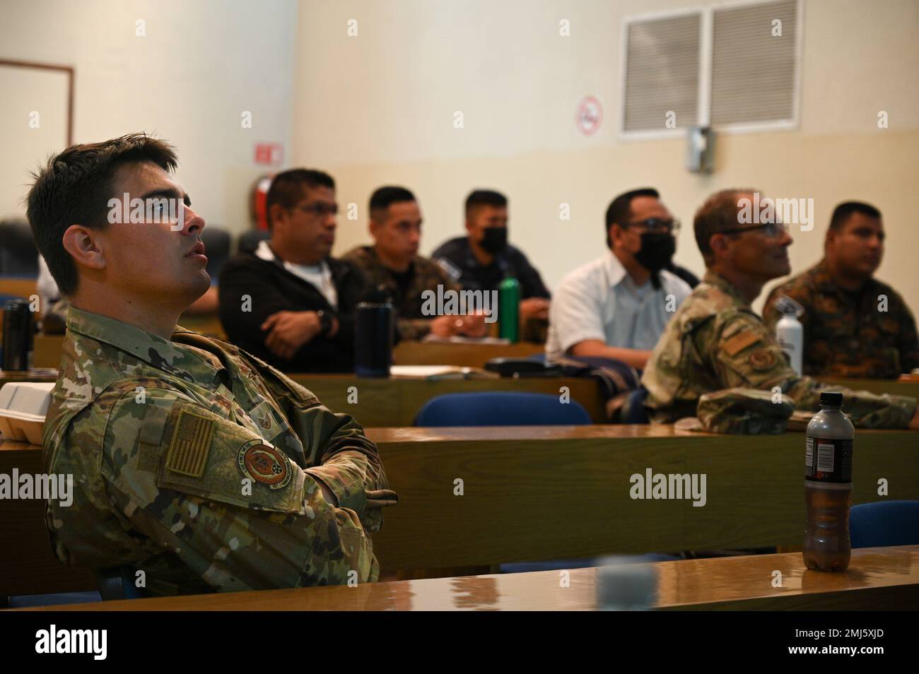 Airmen, Soldiers and civilians from El Salvador and the New Hampshire National Guard listen to a ...