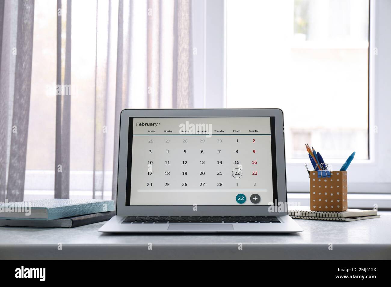 Modern laptop with calendar on screen in office Stock Photo - Alamy