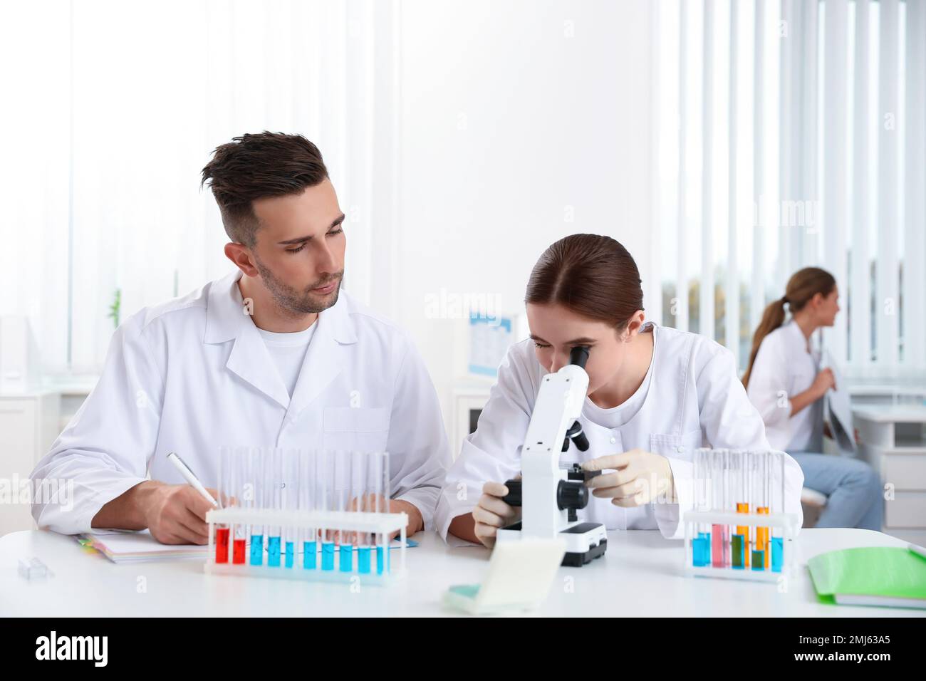 Medical students with microscope in modern laboratory Stock Photo - Alamy