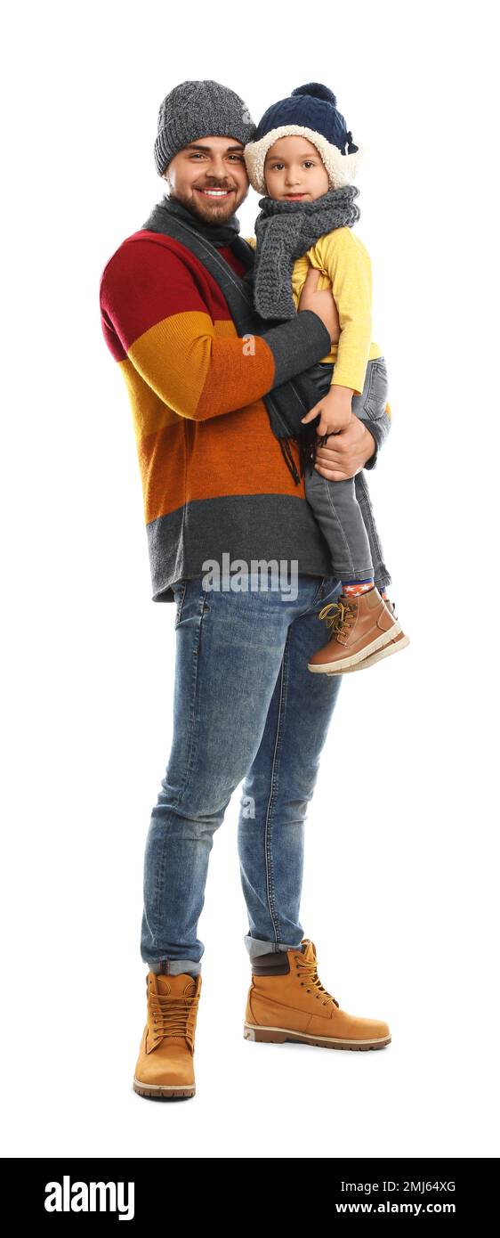 Happy father and son in warm clothes on white background. Winter ...
