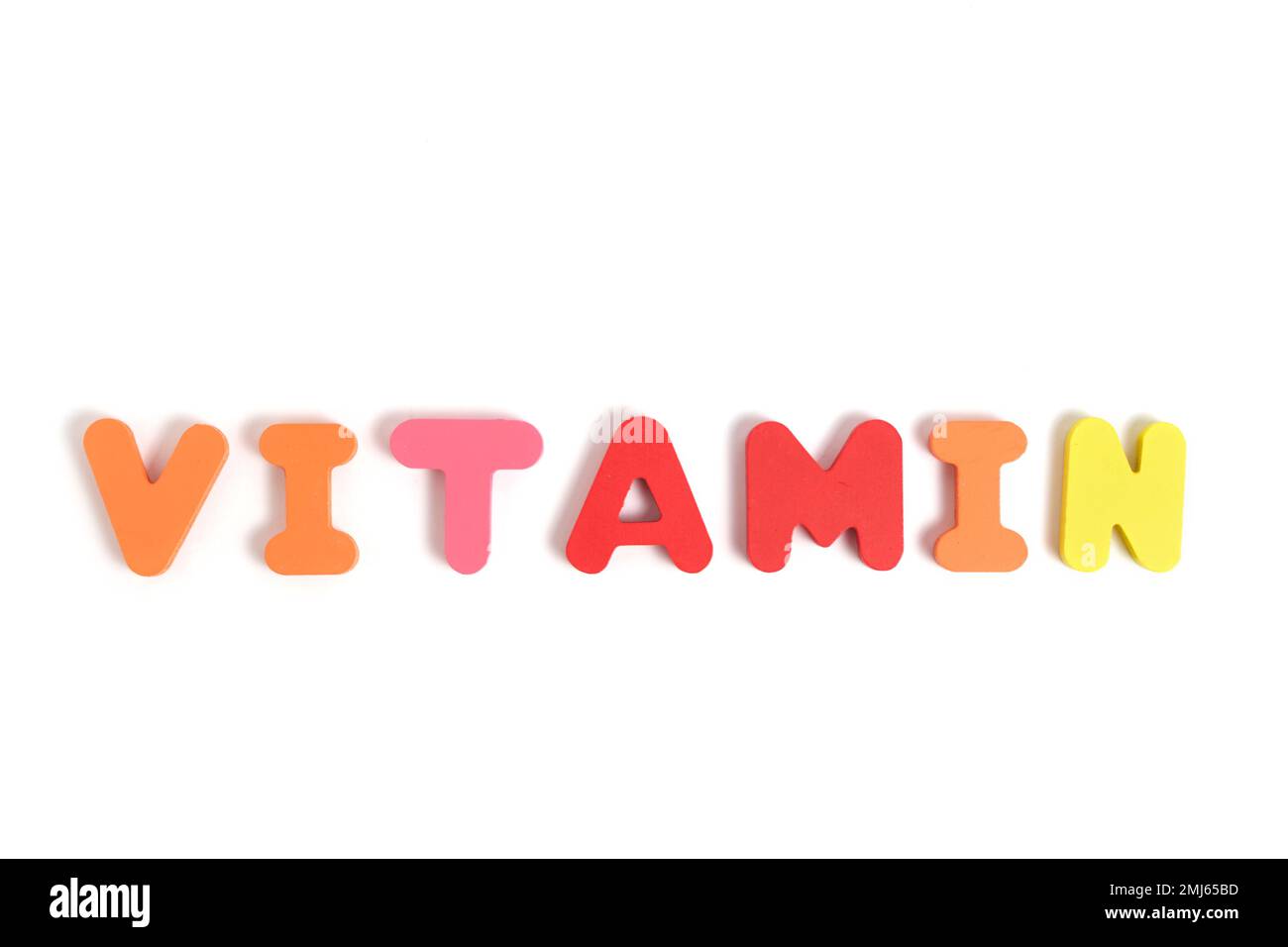 Word vitamin is laid out letters white background Stock Photo - Alamy