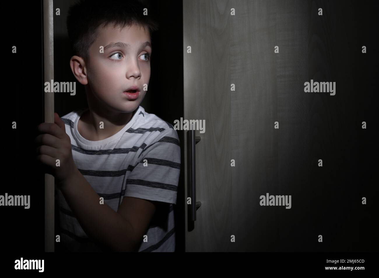 Child boy hiding in wardrobe hi-res stock photography and images - Alamy