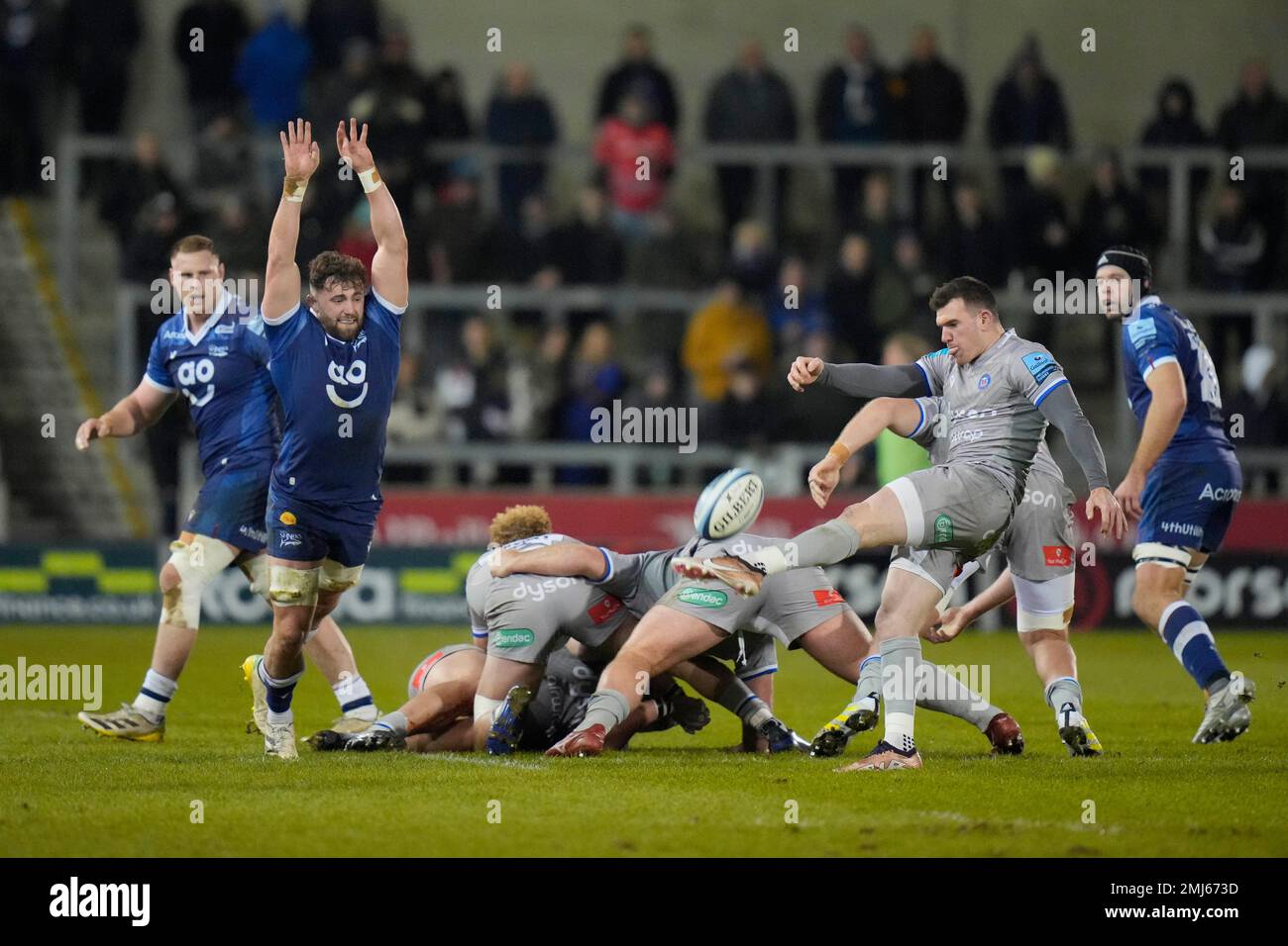 Ben Spencer #9 of Bath Rugby kicks from a ruck under pressure from Sam ...