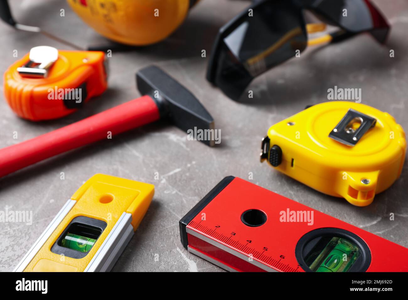 Many different construction tools on grey marble table Stock Photo - Alamy