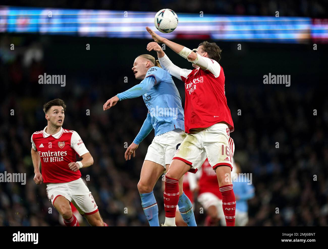 Manchester City's Erling Haaland (left) is clattered by Arsenal's Rob ...