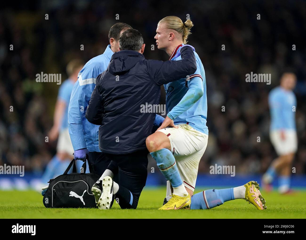Manchester City's Erling Haaland receives treatment after a robust ...