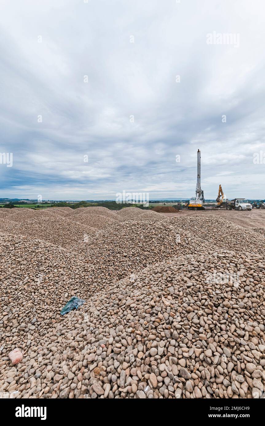 A power shovel, a truck, and a methane gas well drilling rig at an ...