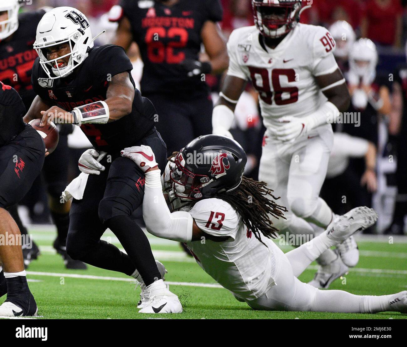 Houston quarterback D'Eriq King, left, is tackled by Washington State ...