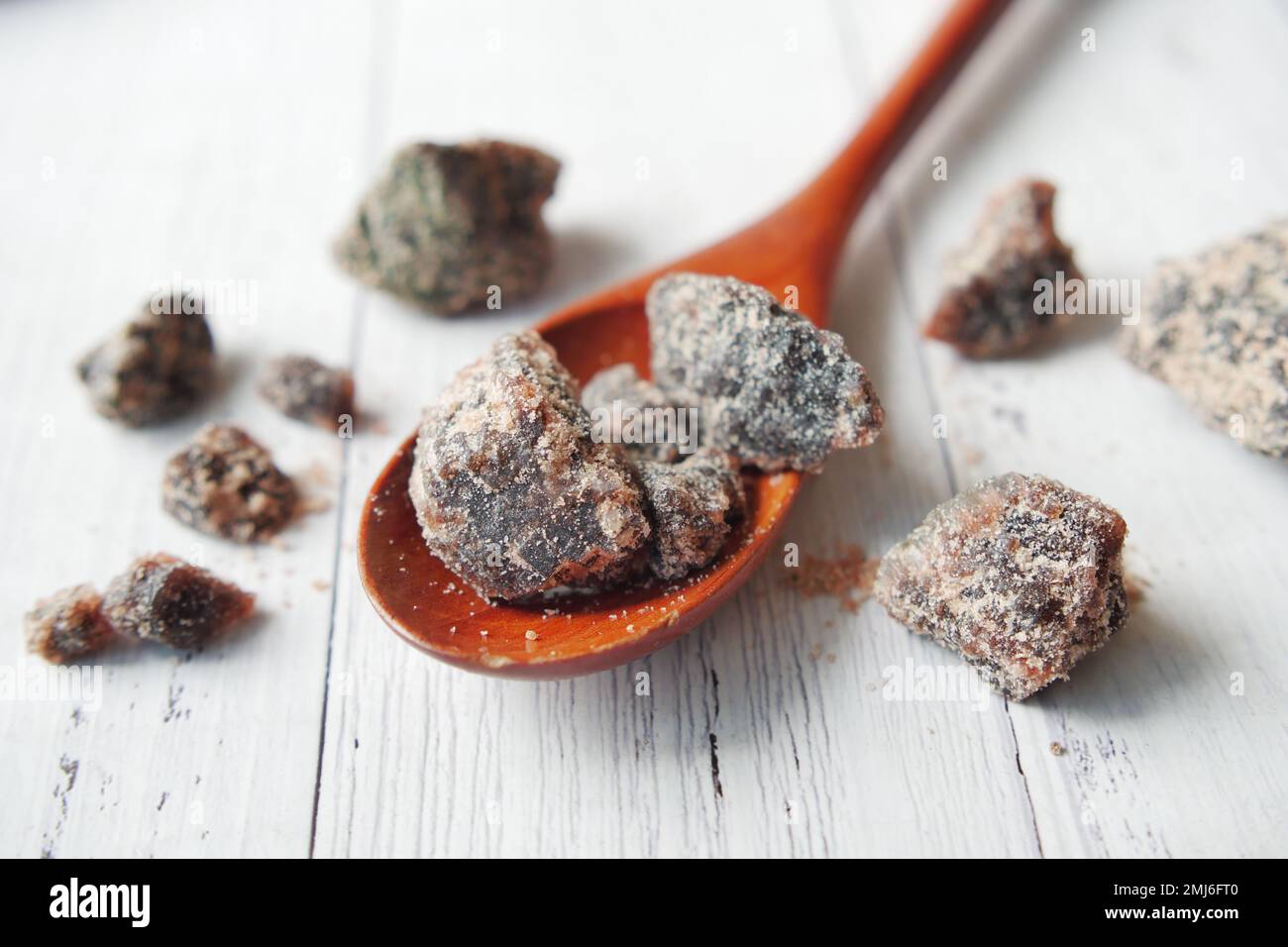 Himalayan black salt rock crystals, Kala Namak in a container on table ...