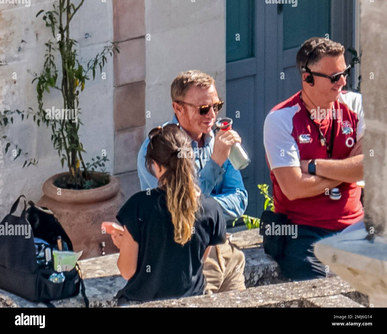 In this Sept. 12, 2019 photo, actor Daniel Craig, center, sips a drink ...