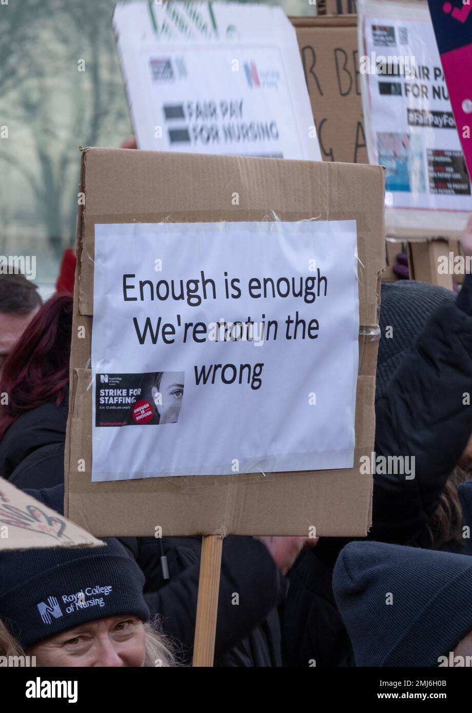 Striking nurses holding signs, demonstrating outside entrance of ...