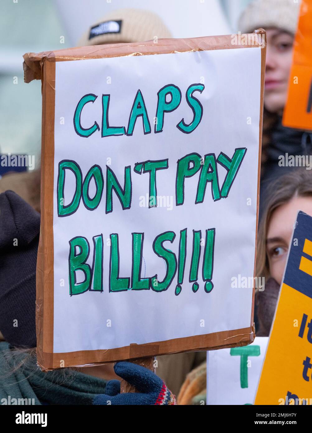 Striking nurses holding signs, demonstrating outside entrance of ...