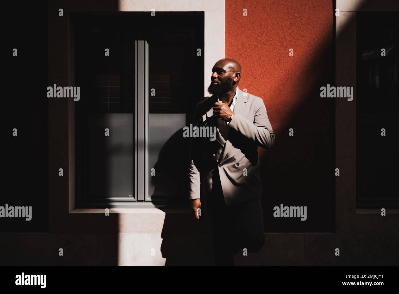 A contrast shot with a fashionable bald African American man with a ...