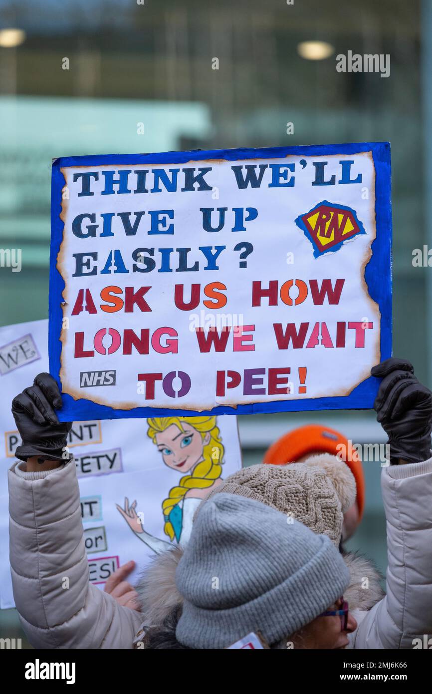 Striking nurses holding signs, demonstrating outside entrance of ...