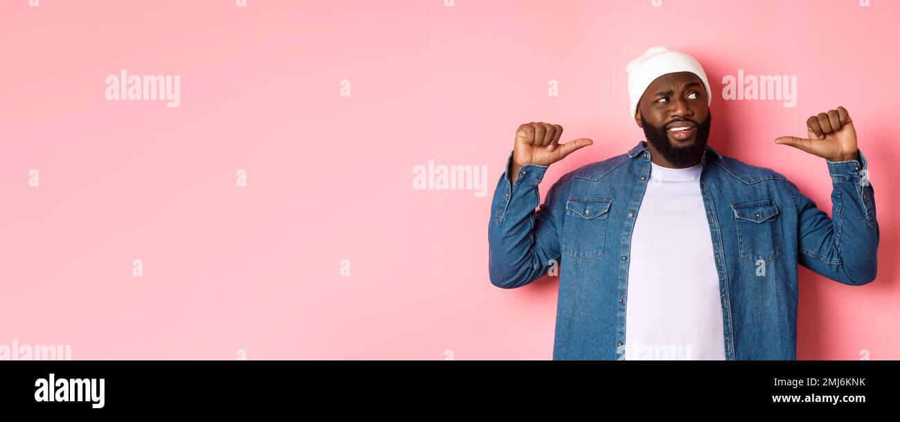 Confused Black Man Staring Right And Pointing At Himself Unsure Having