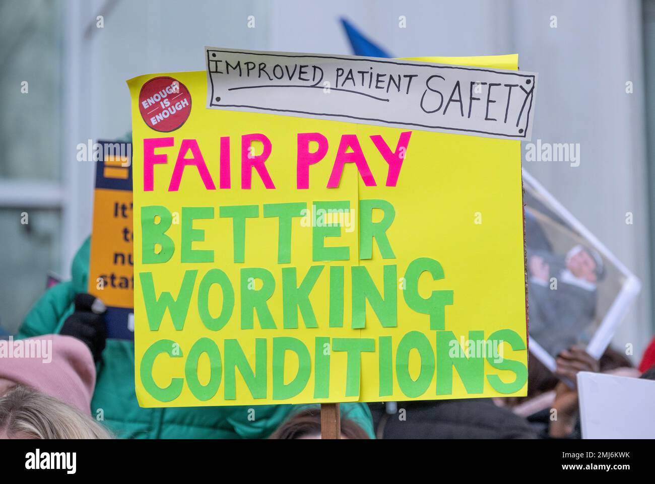 Striking nurses holding signs, demonstrating outside entrance of ...