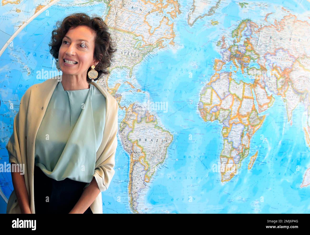UNESCO'S Director-General Audrey Azoulay stands in front of a map at ...