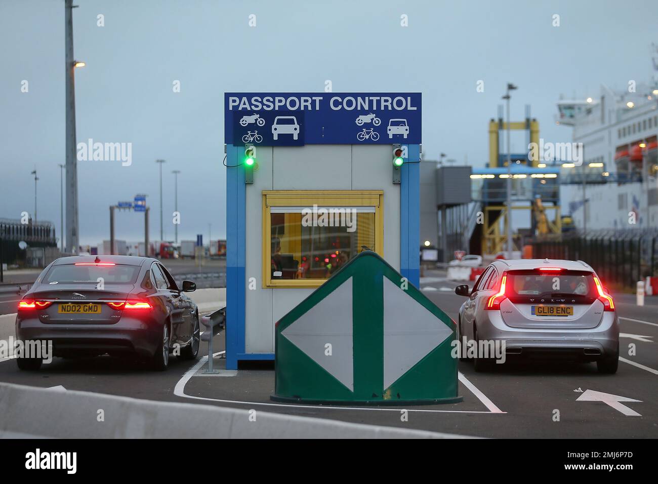 Cars bearing British license plates stop at a passport control booth at ...