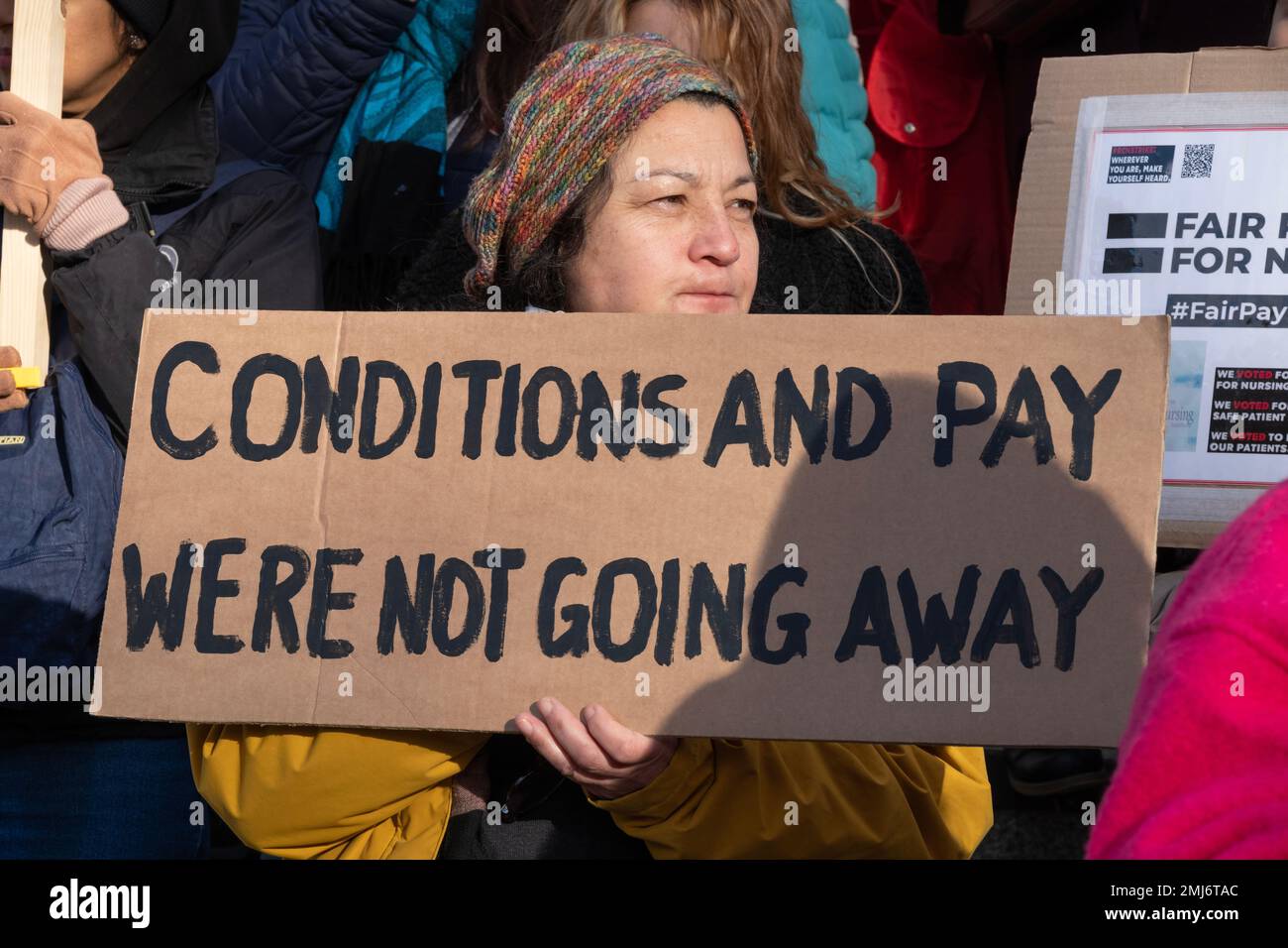 Striking nurses with placards, demonstrating outside University College ...