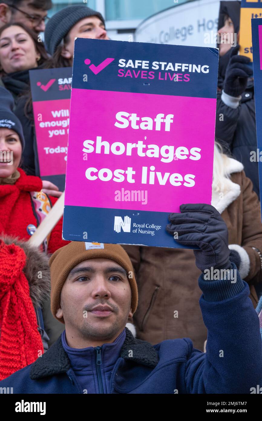 Striking nurses with placards, demonstrating outside University College ...