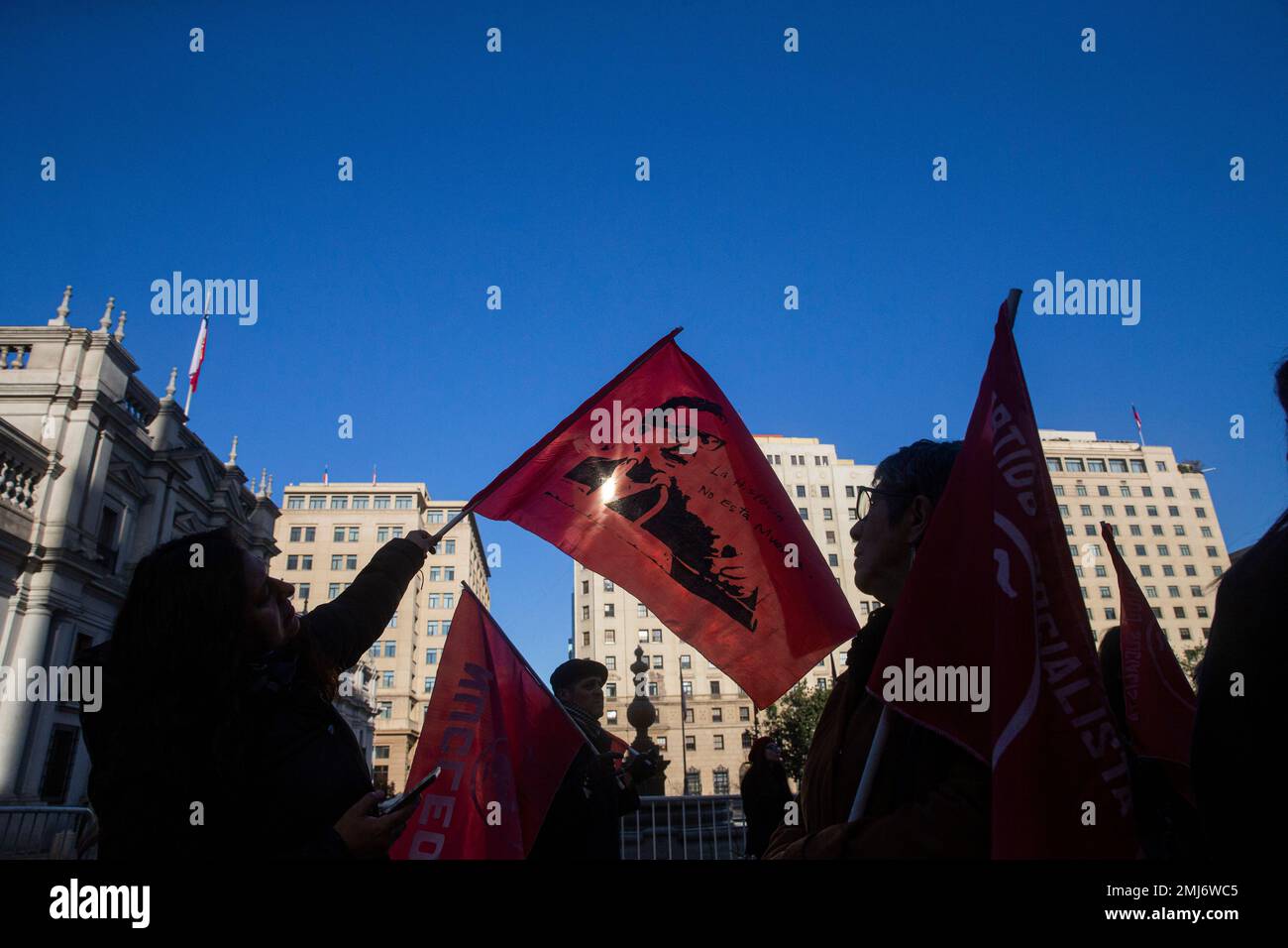 Supporters of Chile’s late President Salvador Allende hold flags with ...