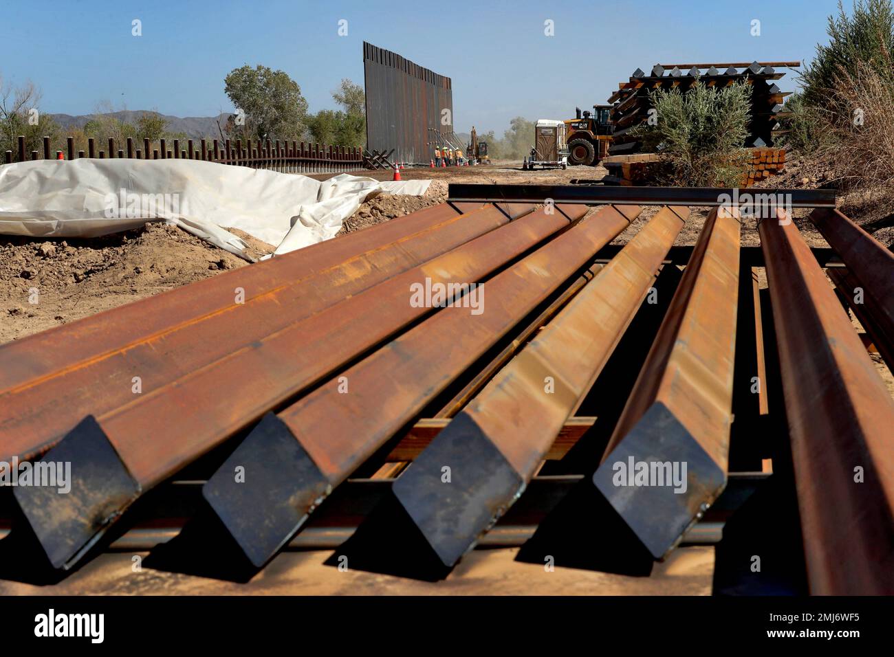 Sections of Pentagon-funded border wall are stacked prior to ...