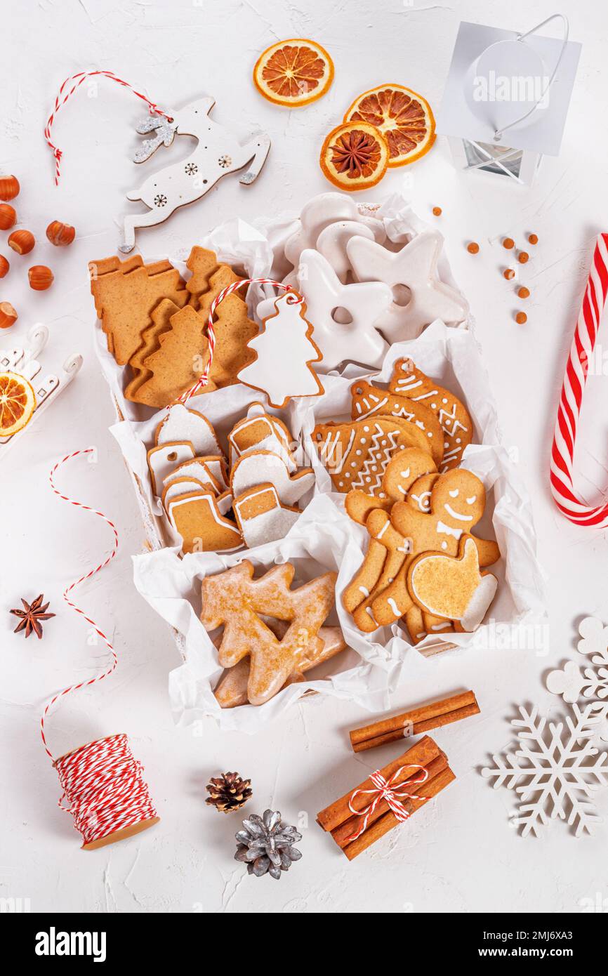 Top view of unpacked christmas present with sweets on a white textured ...