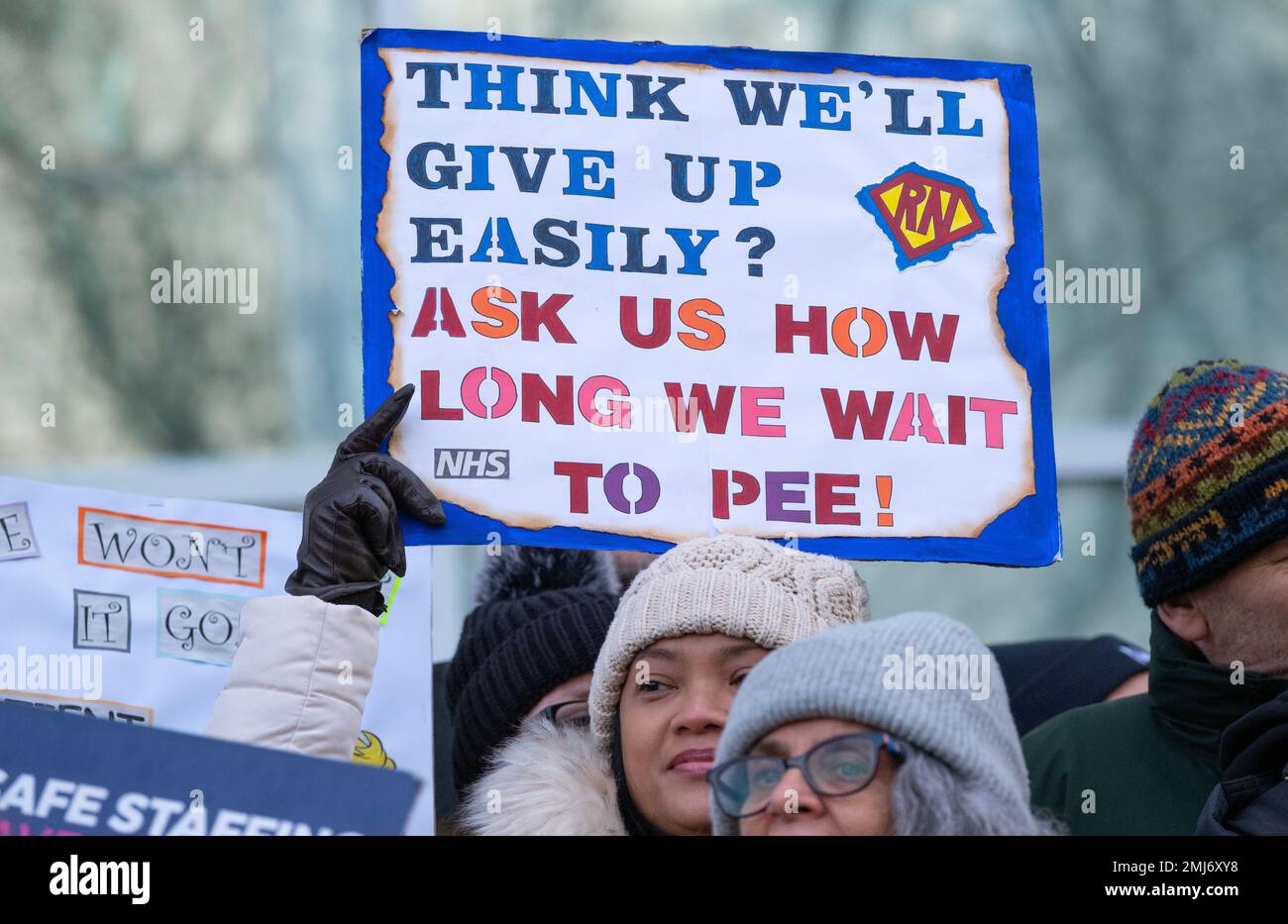 Striking nurses with placards, demonstrating outside University College ...