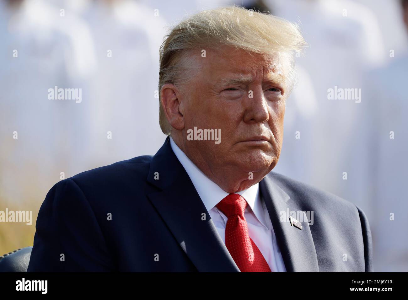 President Donald Trump listens to the program before speaking during a ...