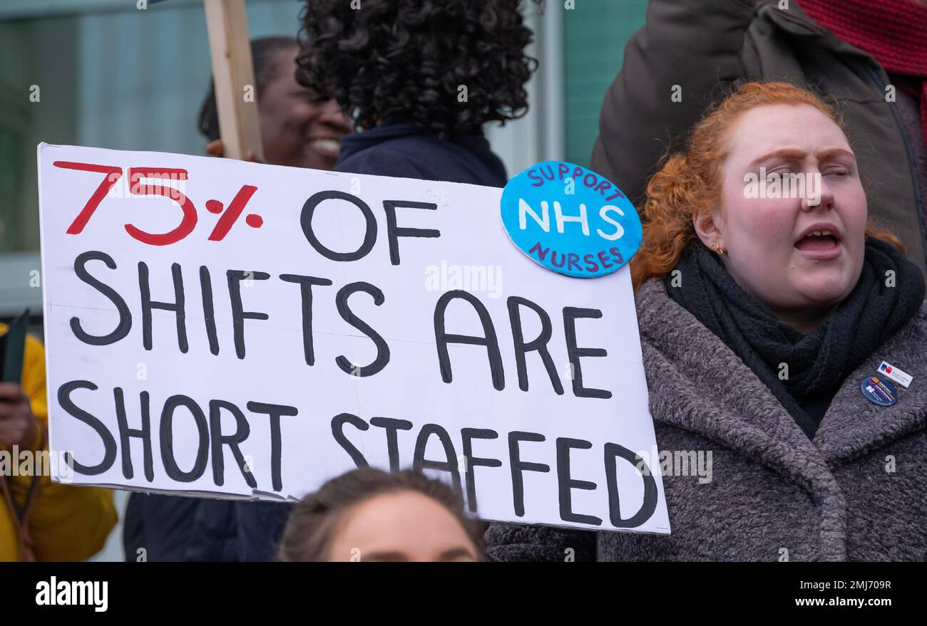 Striking nurses with placards, demonstrating outside University College ...