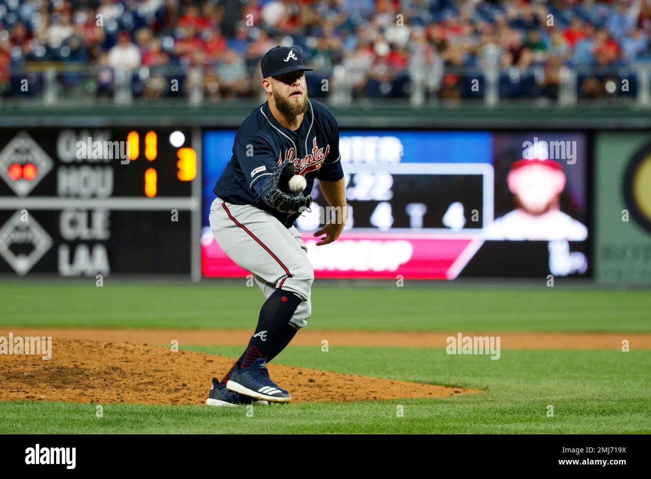 Atlanta Braves relief pitcher A.J. Minter catches a ground out by ...