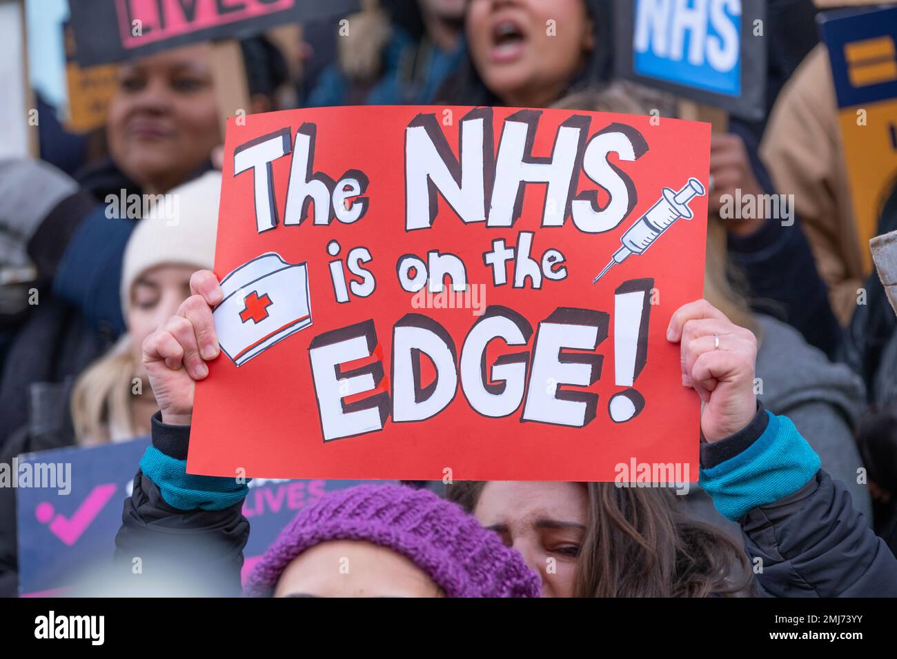 Striking nurses with placards, demonstrating outside University College ...