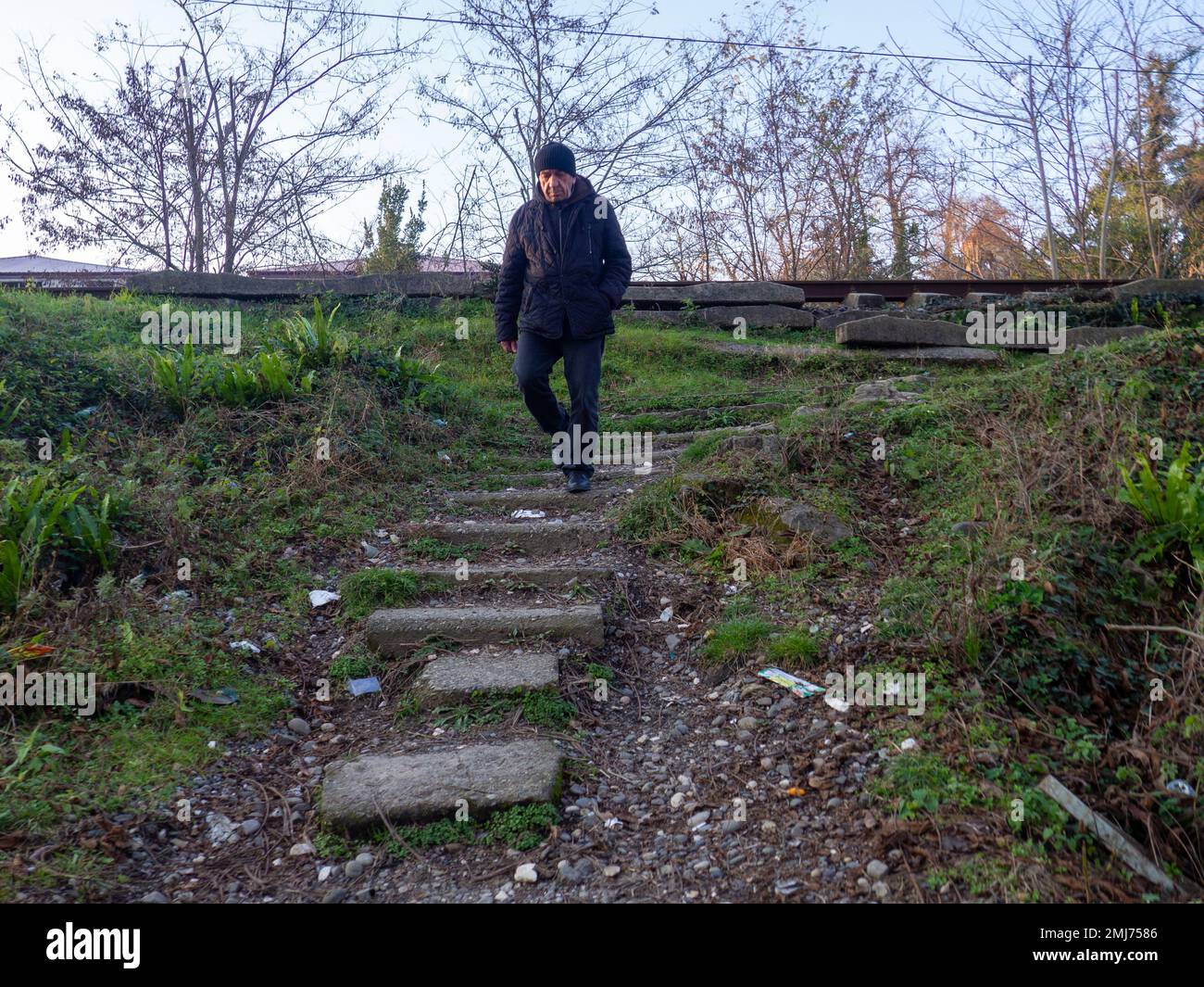 Batumi, Georgia. 12.23.2022 man descends from a railway embankment. The ...