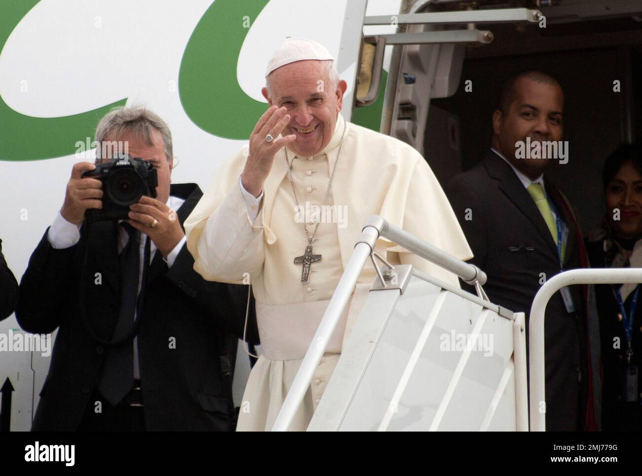 Pope Francis waves goodbye as he boards the plane for Rome at the end ...