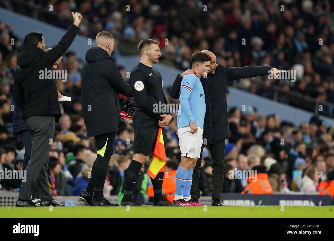 Manchester City manager Pep Guardiola (right) gives instructions to ...