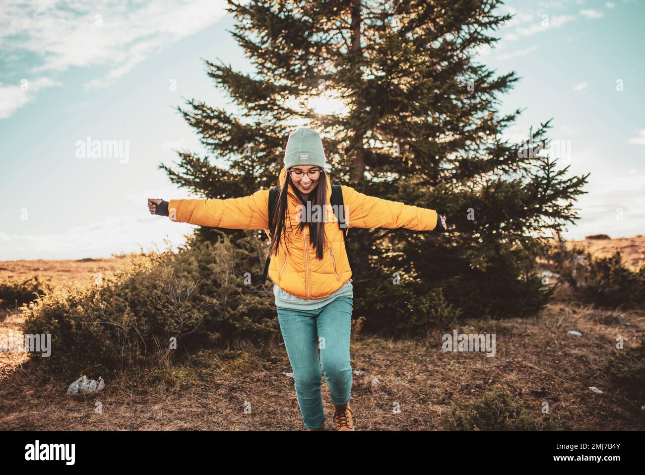 a girl with outstretched arms running through nature Stock Photo - Alamy
