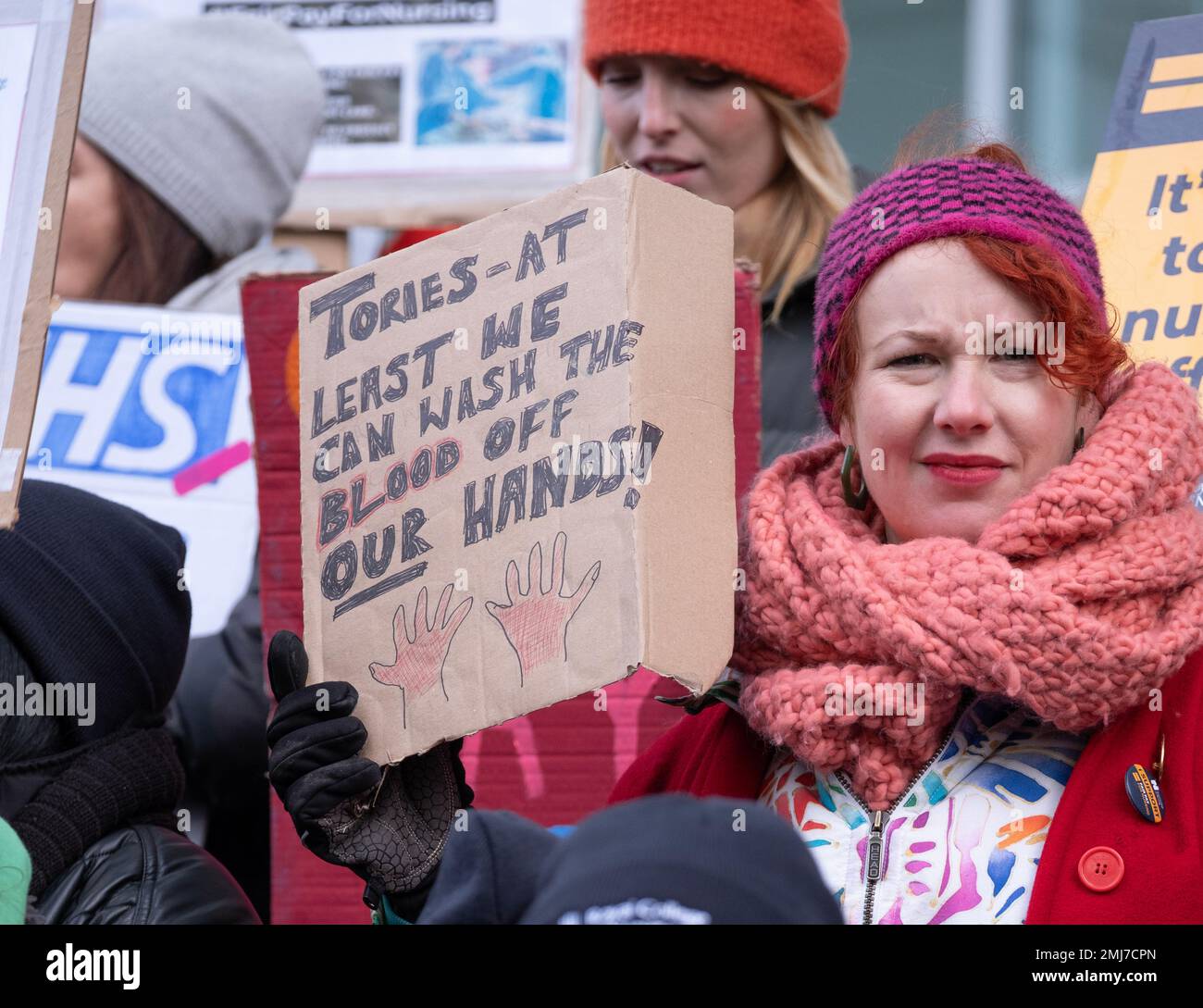 Striking nurses with placards, demonstrating outside University College ...