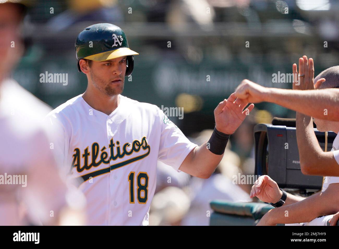 Oakland Athletics' Chad Pinder (18) high fives teammates after scoring ...